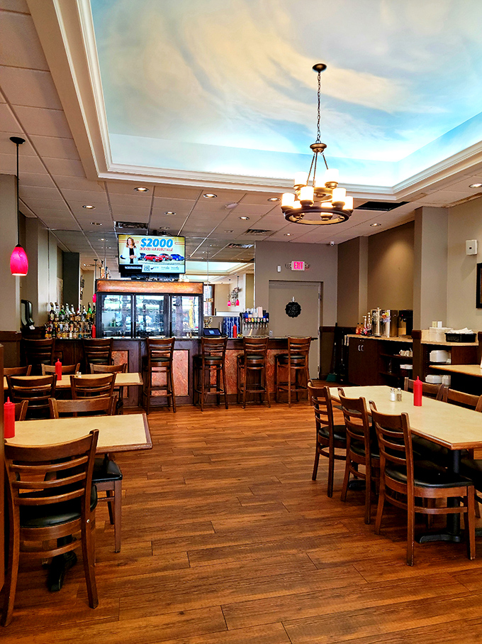 The dining area's warm wood tones and sky-painted ceiling create an atmosphere where lingering over coffee feels not just allowed but encouraged.