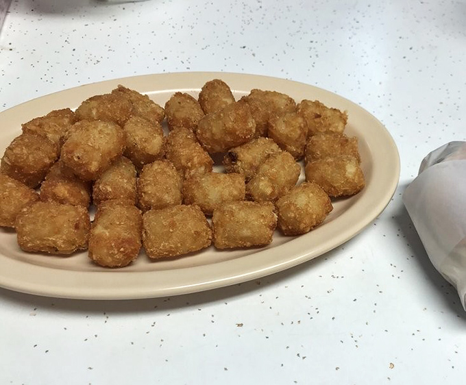 Golden tater tots that achieve the impossible: perfectly crisp exteriors giving way to fluffy potato interiors&mdash;the unsung heroes of any proper Southern plate.