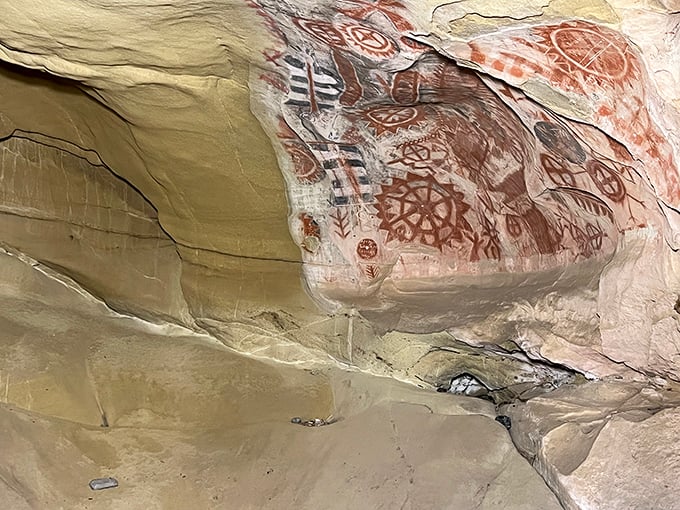 The vibrant red ochre pictographs have survived centuries, their celestial patterns and geometric designs still captivating visitors who make the winding journey uphill.