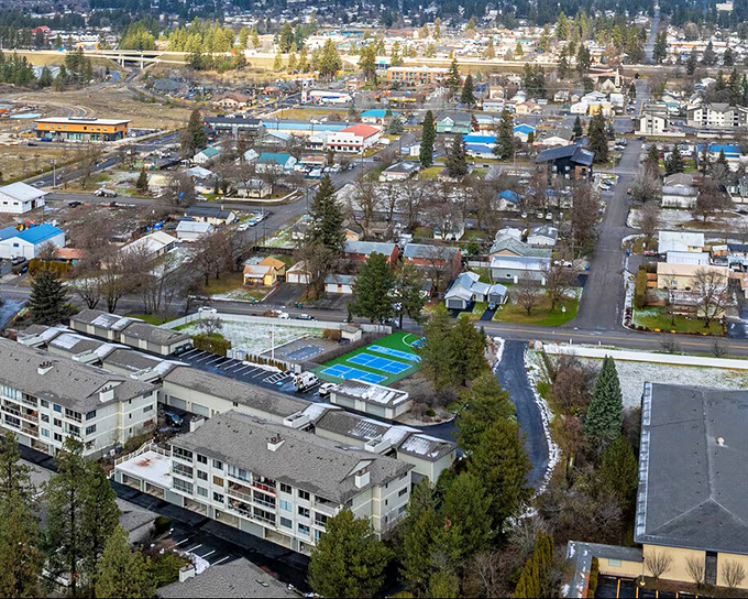 A patchwork of neighborhoods nestled among evergreens&mdash;Post Falls' development respects rather than replaces its natural setting.