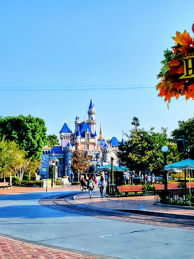 Morning light bathes the castle in golden hues as early visitors begin their day of discovery along Main Street.