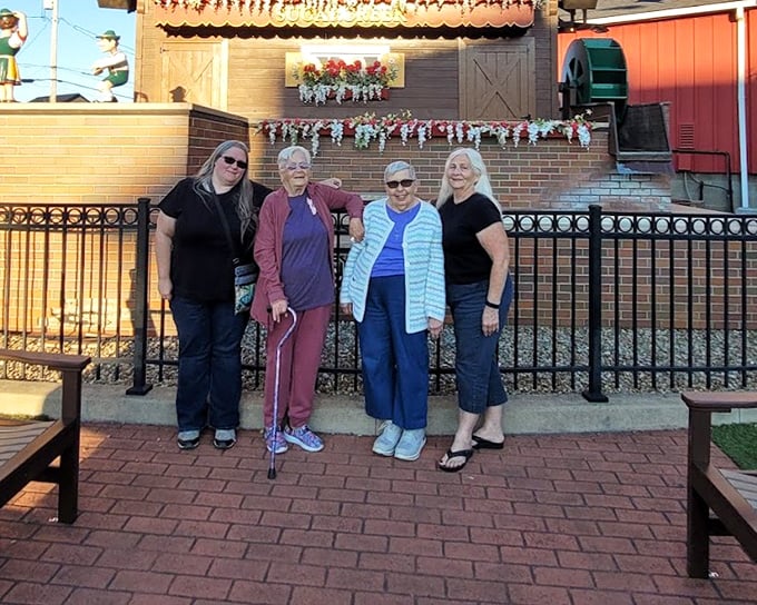 Four generations gather for the obligatory "we were here" photo, creating memories that will outlast any refrigerator magnet souvenir.