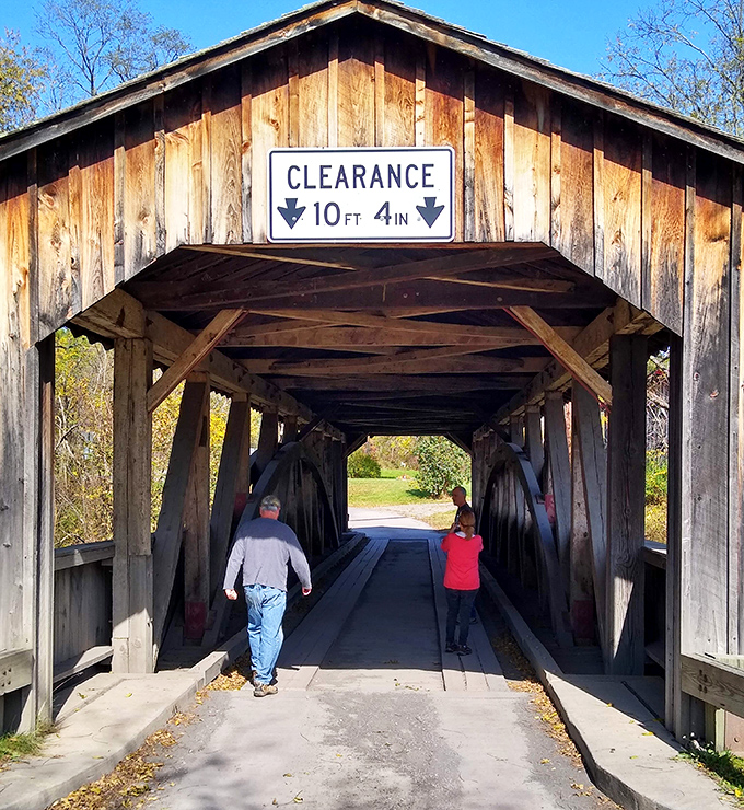 Visitors provide scale to this historical giant. Walking through, they become part of a tradition that stretches back generations.