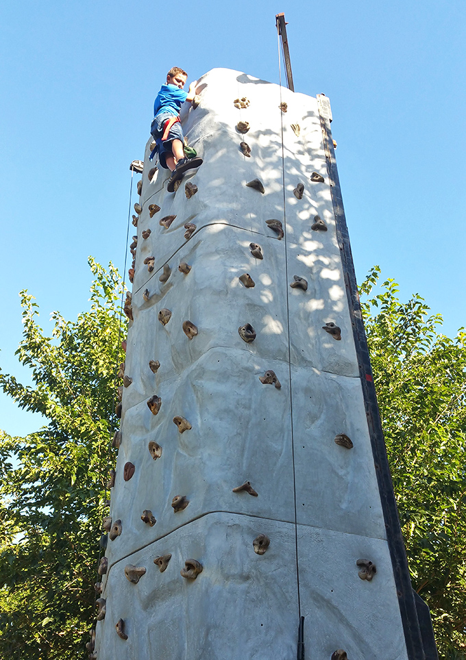 Young adventurers scale the climbing wall, reaching heights that seem more impressive when you're still counting your age on fingers.