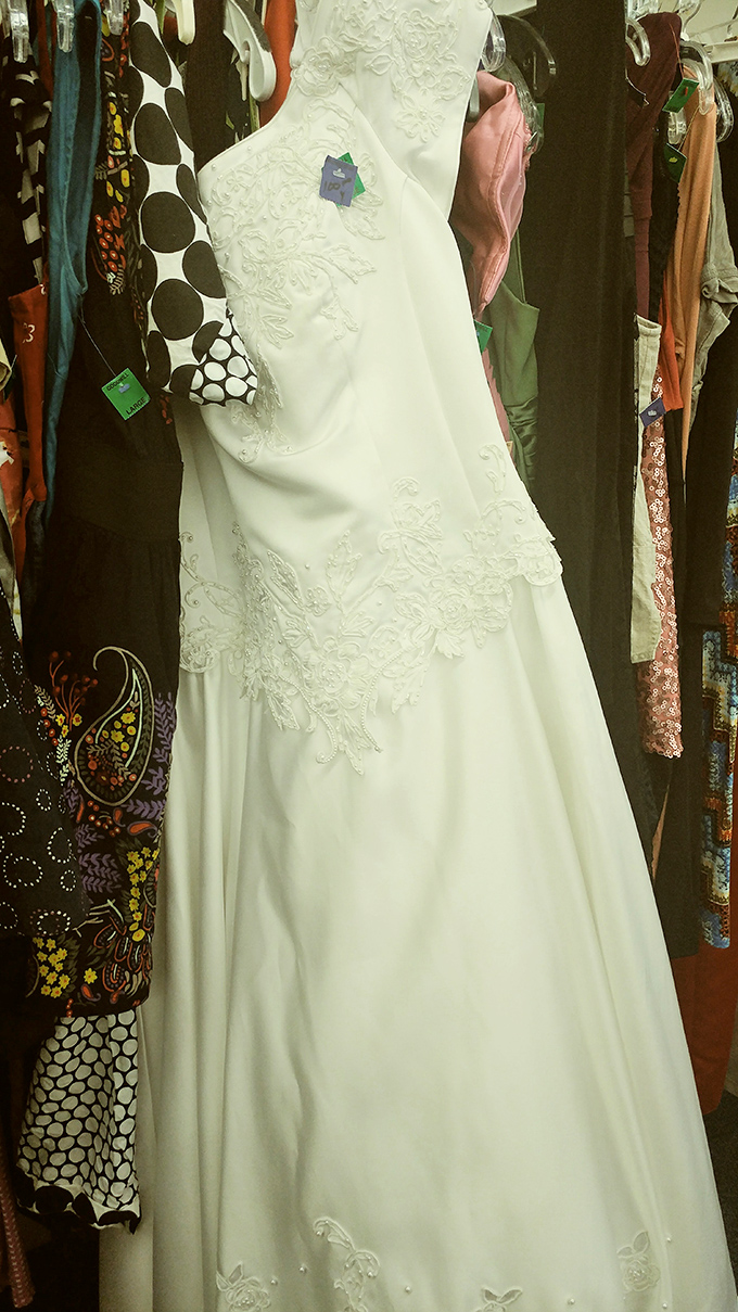 That wedding dress with delicate embroidery and pristine condition begs the question: was it ever worn, or did someone's cold feet become your wardrobe win?