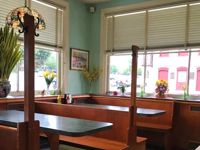 Stained glass lamps and mint-green walls&mdash;this isn't interior design, it's time travel to when conversations happened face-to-face.