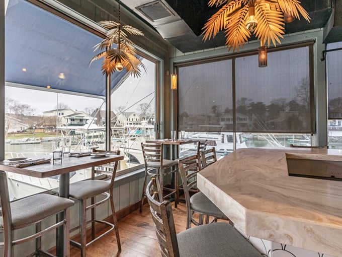 Window seating that turns an ordinary meal into dinner theater, with boats and water views providing the entertainment no Netflix show can match.