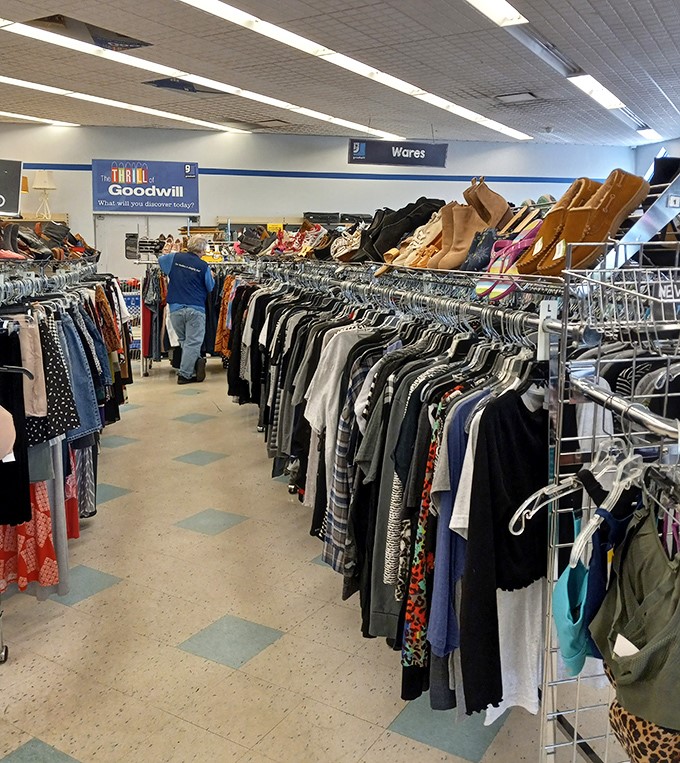 The Thrill of Goodwill sign says it all. Racks of clothing create a textile forest to explore.