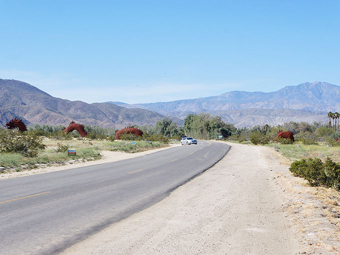 Borrego Springs' desert landscape stretches toward distant mountains. Those metal sculptures add whimsical touches to nature's canvas.