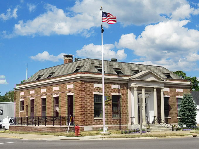 The historic brick office in Boyne City stands proudly under blue skies, a testament to small-town America's enduring charm.