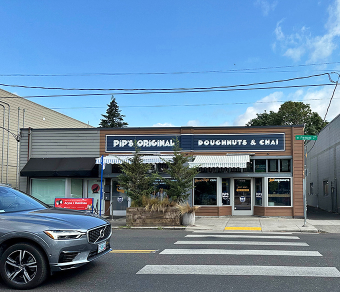 Pip's blue-and-wood exterior hints at the craftsmanship within. This isn't just a donut shop—it's a tiny donut workshop.