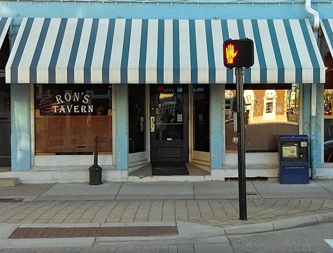 Blue and white stripes signal small-town charm where pizza perfection meets Main Street magic.