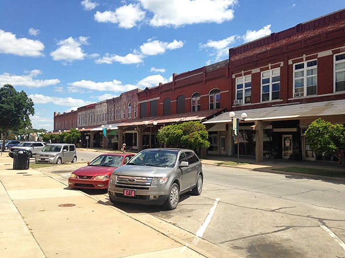 These connected storefronts create a continuous covered walkway, proving that old-timey architects understood Kansas weather better than modern planners do.