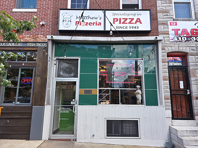 The green and white fa&ccedil;ade of Matthew's hints at the old-school pizza experience waiting inside.