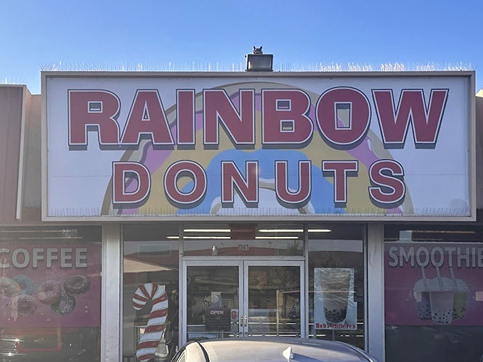 The bold signage of Rainbow Donuts promises colorful treats inside. Where fritters reach epic proportions and glazed donuts achieve perfection.