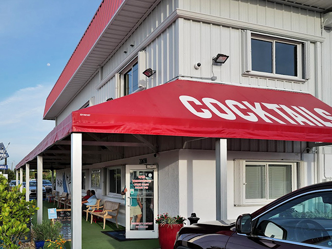 Red awnings and island architecture promise laid-back dining where fresh grouper meets Keys-style hospitality.