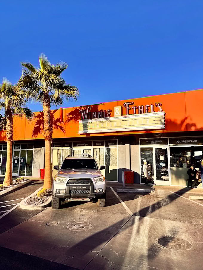 Those swaying palms and orange sunset colors make every meal feel like a vacation from ordinary dining.