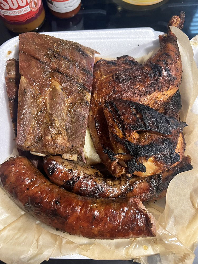 The holy trinity of barbecue&mdash;ribs, chicken, and sausage sharing a plate like old friends at a reunion. No favorites here, just excellence.
