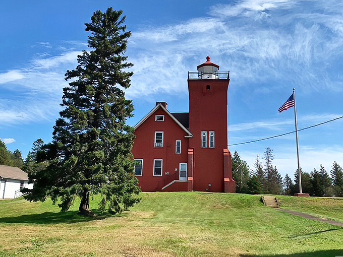 Two Harbors' historic lighthouse stands as a crimson sentinel, greeting train passengers just as it has welcomed ships for generations.