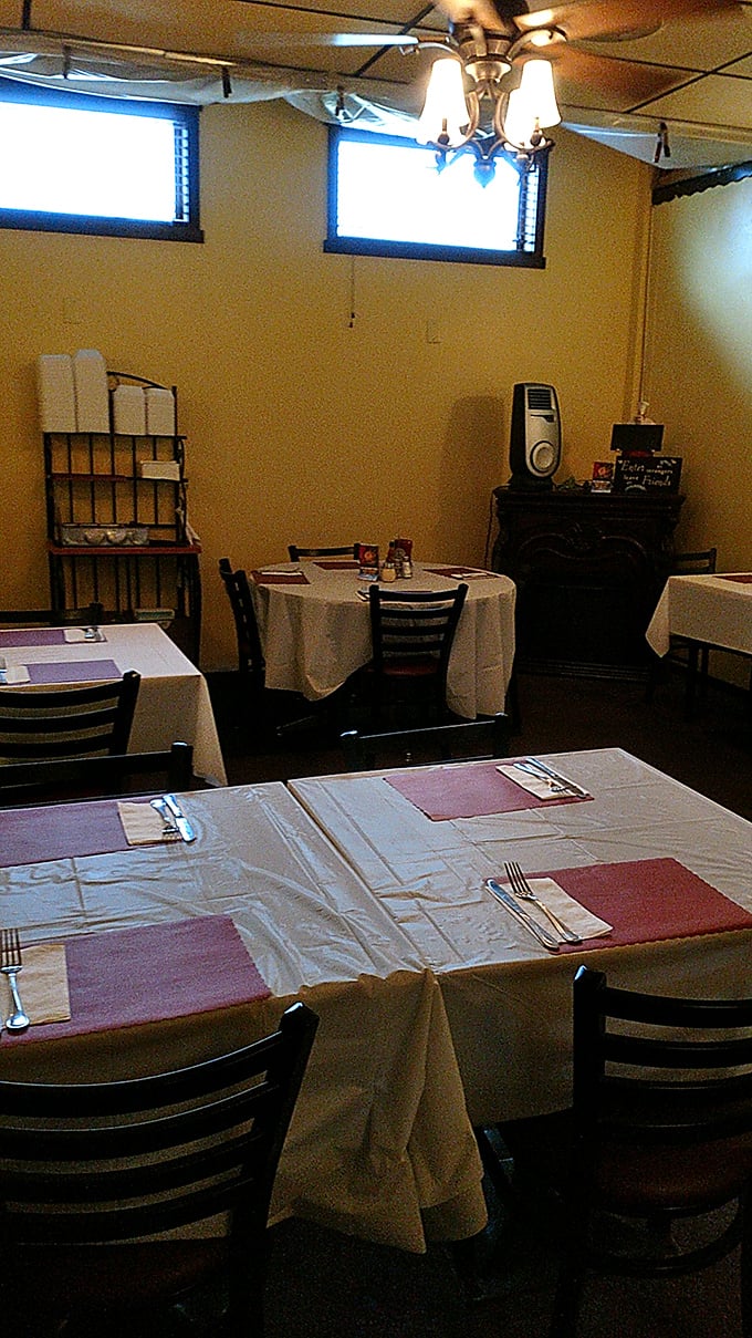 Dining tables await their next guests, each setting a blank canvas for the culinary masterpieces that will soon grace these white tablecloths.