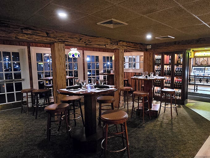 Evening light streams through windows into this cozy corner, where high-top tables await those who prefer their steak with a side of people-watching.