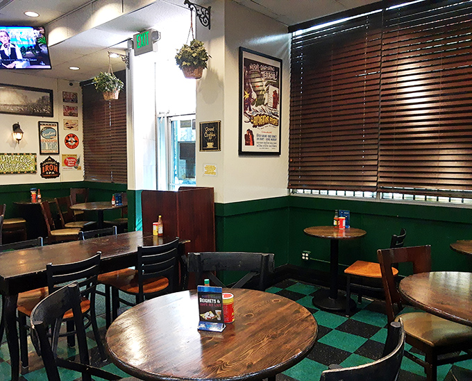 Green wainscoting, wooden tables, and New Orleans posters create that perfect "come as you are" vibe where both celebrities and locals feel equally at home.