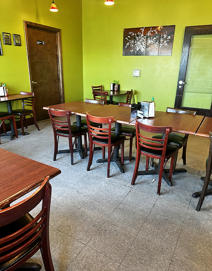 Lime green walls and simple furnishings create a no-nonsense dining space where the food, not the decor, rightfully remains the star of the show.