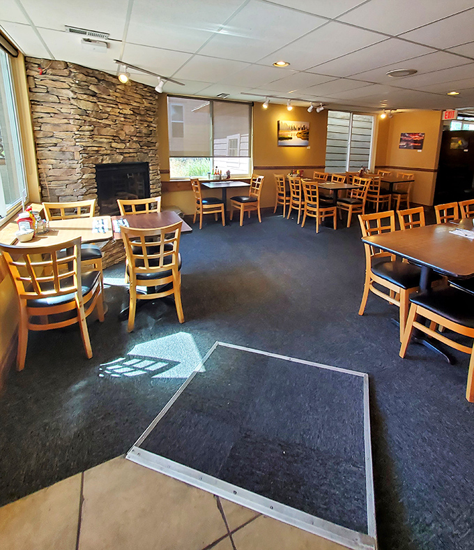 Stone fireplace meets wooden tables in a dining room that feels like the cozy mountain lodge you've always wanted to call home.