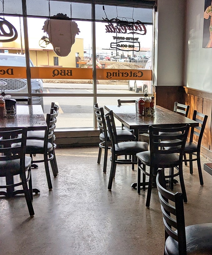 Another angle of barbecue simplicity. Large windows flood the space with natural light, highlighting the clean, straightforward approach to dining here.