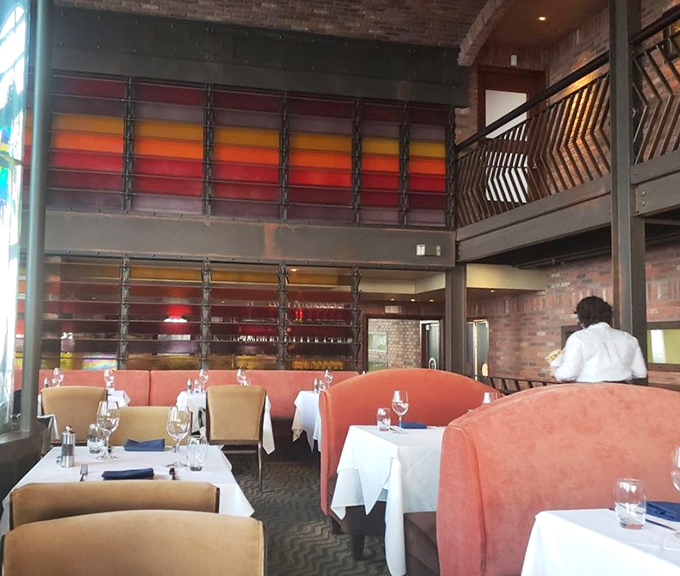 The dining room's coral banquettes and warm brick walls create the perfect backdrop for both first dates and anniversary celebrations.