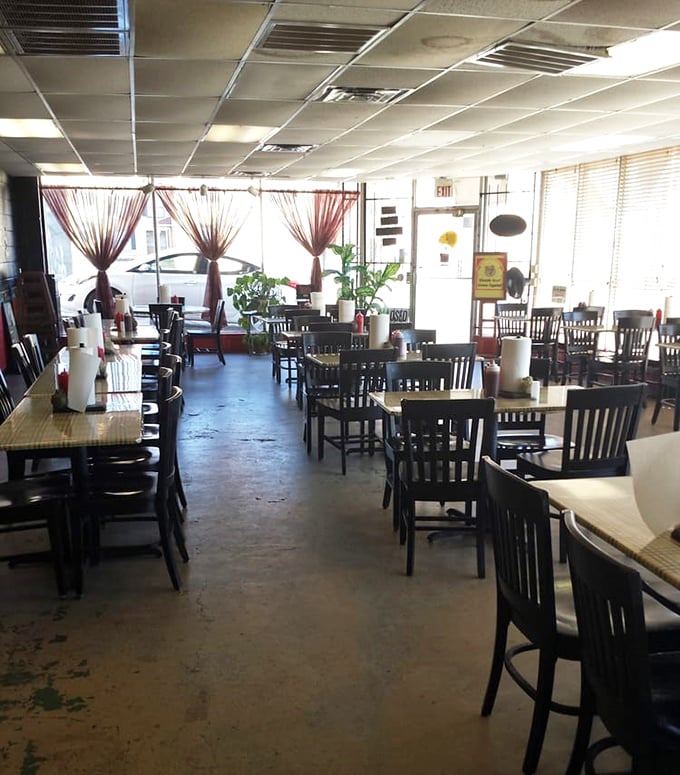 Simple tables, paper towel rolls, and burgundy curtains filtering the light—barbecue doesn't need fancy surroundings when the food does the talking.