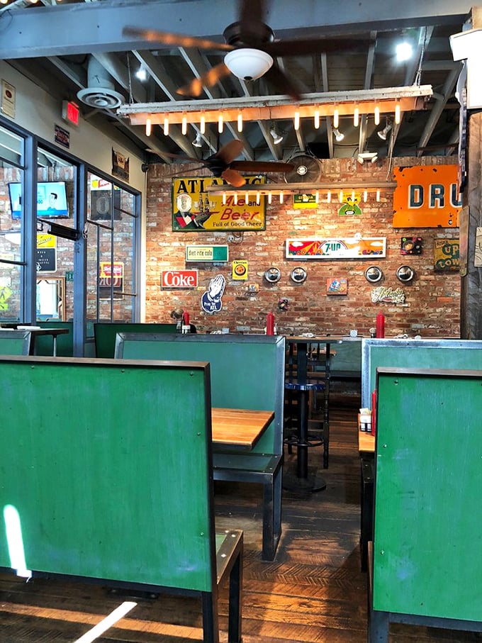 Green booth dividers create intimate dining pockets while exposed brick walls showcase a collection of vintage signs that practically narrate Atlanta's history.