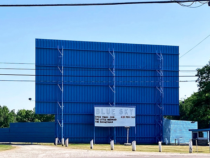 The iconic blue backdrop isn't just a fence&mdash;it's the dividing line between ordinary life and the extraordinary world of outdoor cinema.