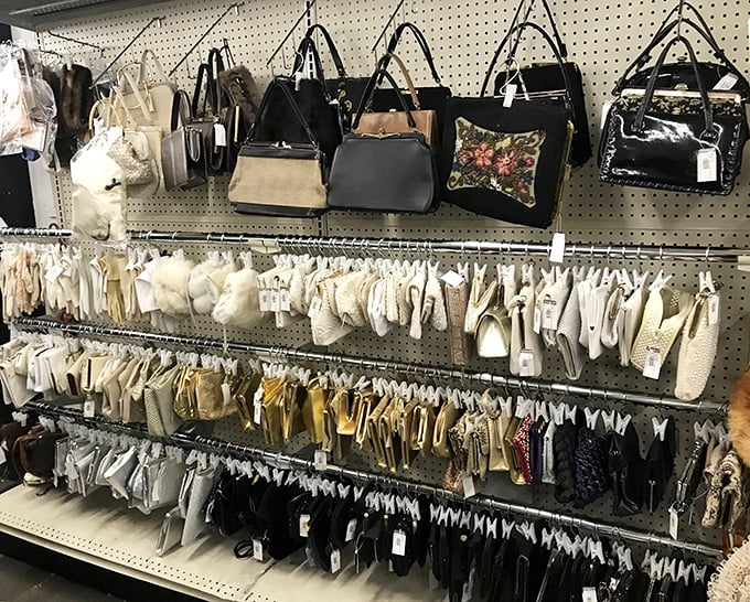 The handbag wall: where designer dreams meet practical budgets, and yesterday's fashion statements await their triumphant return to stylish shoulders.