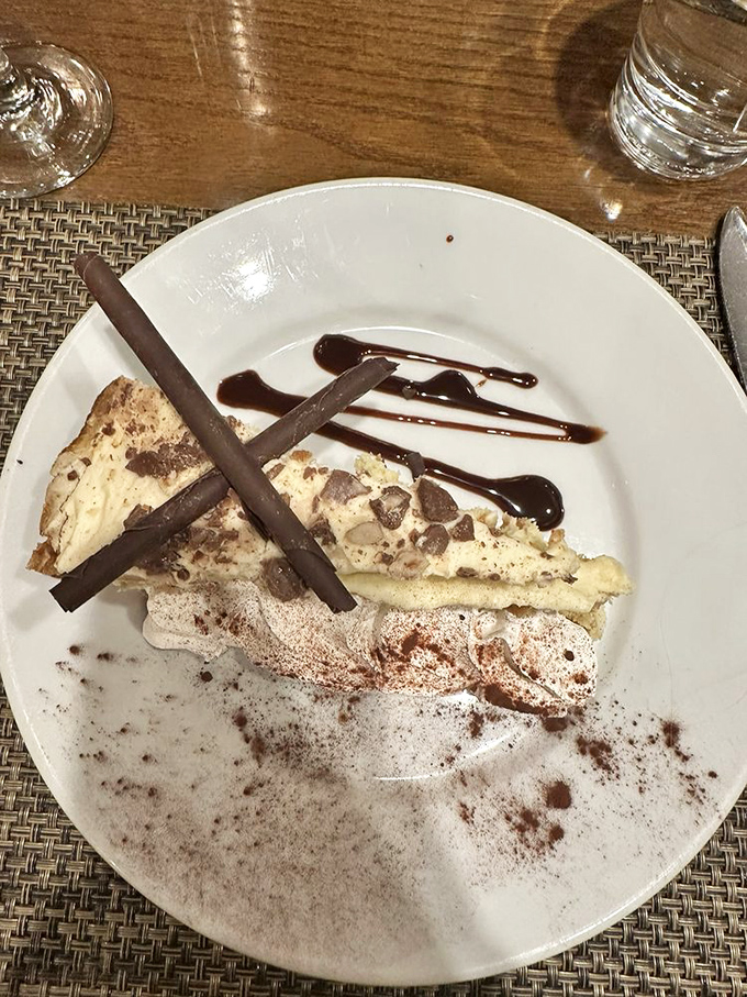 This isn't just dessert, it's a chocolate-drizzled reason to save room, featuring layers that deserve their own architectural award.