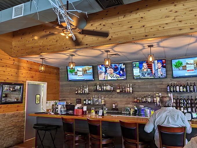 The bar area combines rustic wood with modern screens&mdash;perfect for catching the game while waiting for your table or making new friends over old fashioneds.