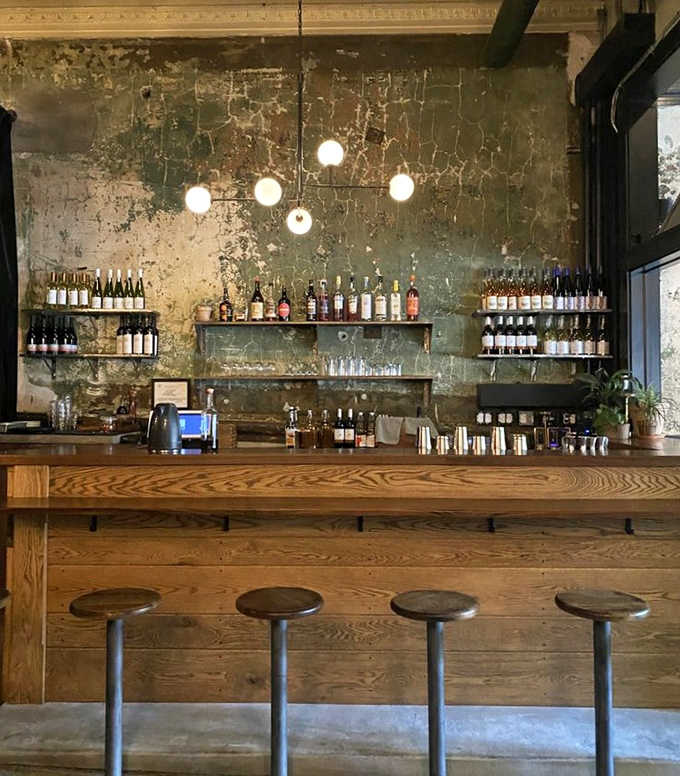 The bar area balances rustic and refined &ndash; weathered walls and warm wood create the perfect backdrop for their thoughtfully curated wine selection.