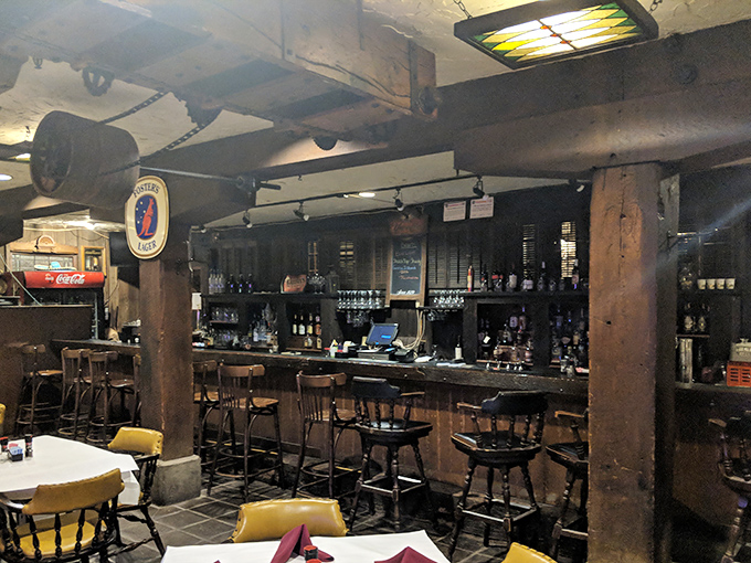 The bar area maintains the building's industrial charm&mdash;where wooden beams and exposed pipes create the perfect backdrop for craft cocktails.