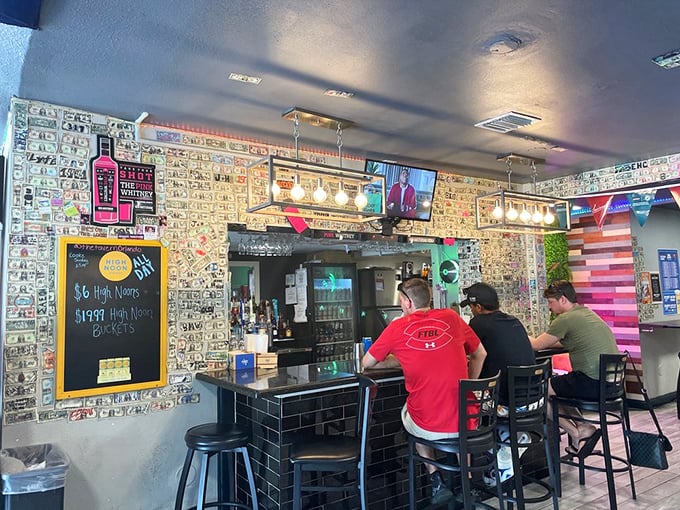 The bar beckons with its colorful dollar bills and photos covering every inch, each one telling a story you'll never hear.