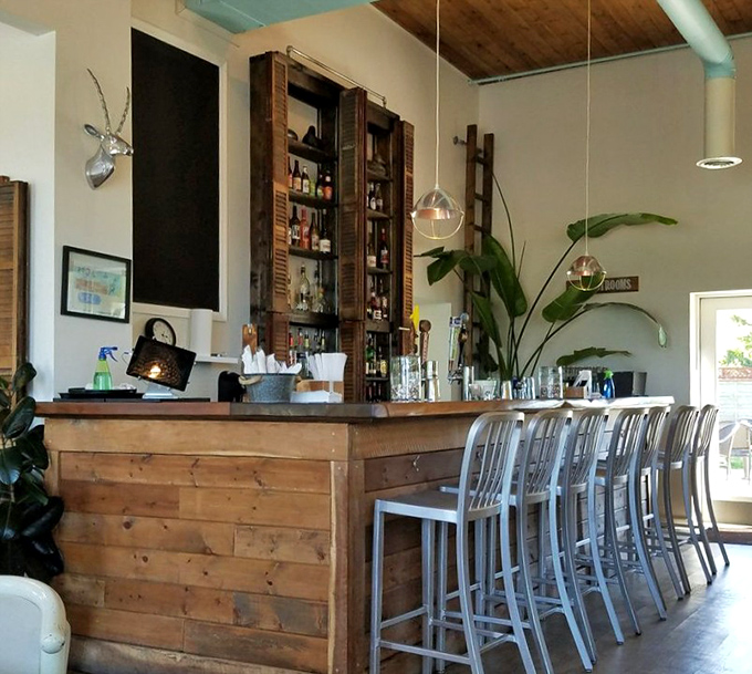 The bar isn't just functional&mdash;it's a wooden masterpiece where craft drinks are poured and food envy spreads faster than gossip.