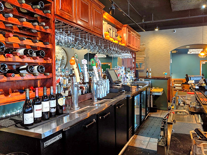 The well-stocked bar promises liquid artistry to complement the kitchen's creations, with wine bottles standing at attention like eager soldiers.