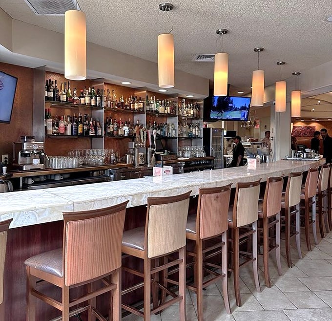 The elegant bar invites you to pull up a seat and watch the bartenders work their magic&mdash;liquid prelude to the seafood symphony awaiting.