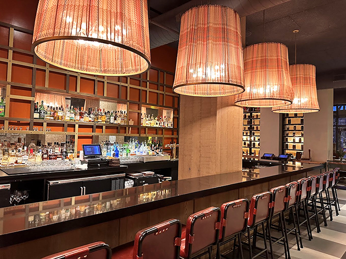 The bar where liquid alchemy happens beneath warm lamplight. Those stools have heard some stories &ndash; and are ready for yours.
