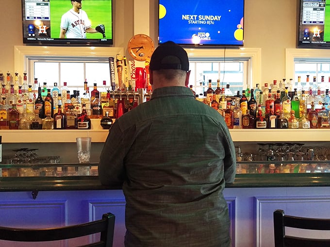 The bar&mdash;where local stories flow as freely as the drinks. Those bottles aren't just spirits; they're conversation starters waiting to happen.