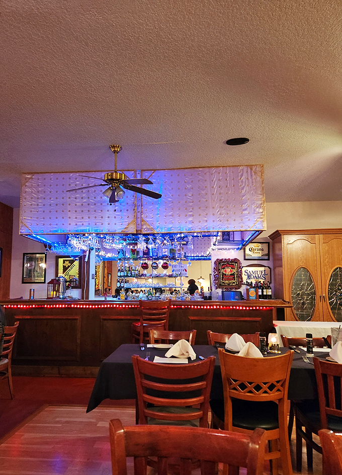 The bar area glows with blue light and possibility. Where stories are shared and friendships forged over perfectly mixed drinks. 