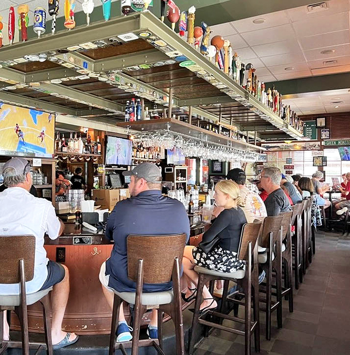 The bar stretches invitingly, lined with locals who've discovered that sometimes the best cocktails happen far from the tourist crowds.