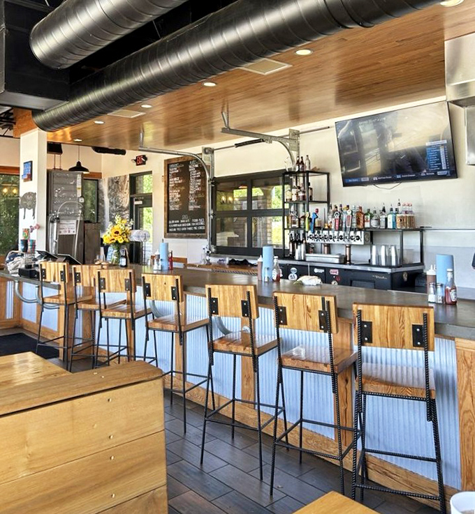 The bar area doesn't just serve drinks&mdash;it offers front-row seats to the barbecue theater, complete with industrial-chic lighting and wood-warm ambiance.