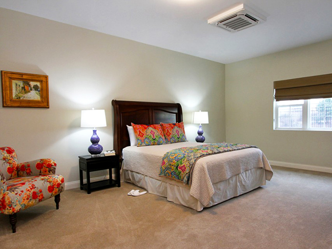 A bedroom that says "boutique hotel" rather than "senior living." The colorful accents add personality without sacrificing sophistication.