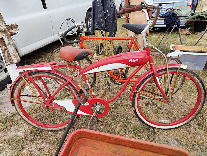 This cherry-red vintage cruiser isn't just a bicycle; it's a time machine with pedals, ready to transport you back to simpler days.