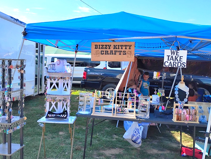 Bizzy Kitty Crafts represents the entrepreneurial spirit of flea markets, where passion projects become small businesses under a simple blue tent.